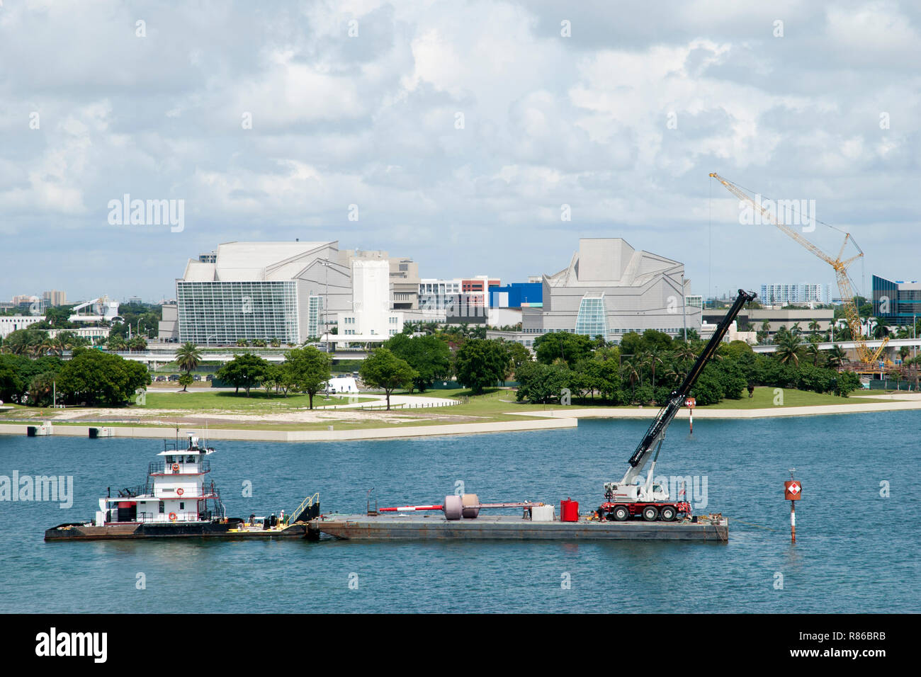 The view of a tugboat and drifting platform with a crane in Miami ...