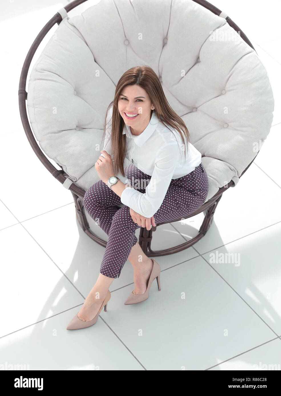 top view.young woman sitting in soft round chair Stock Photo - Alamy