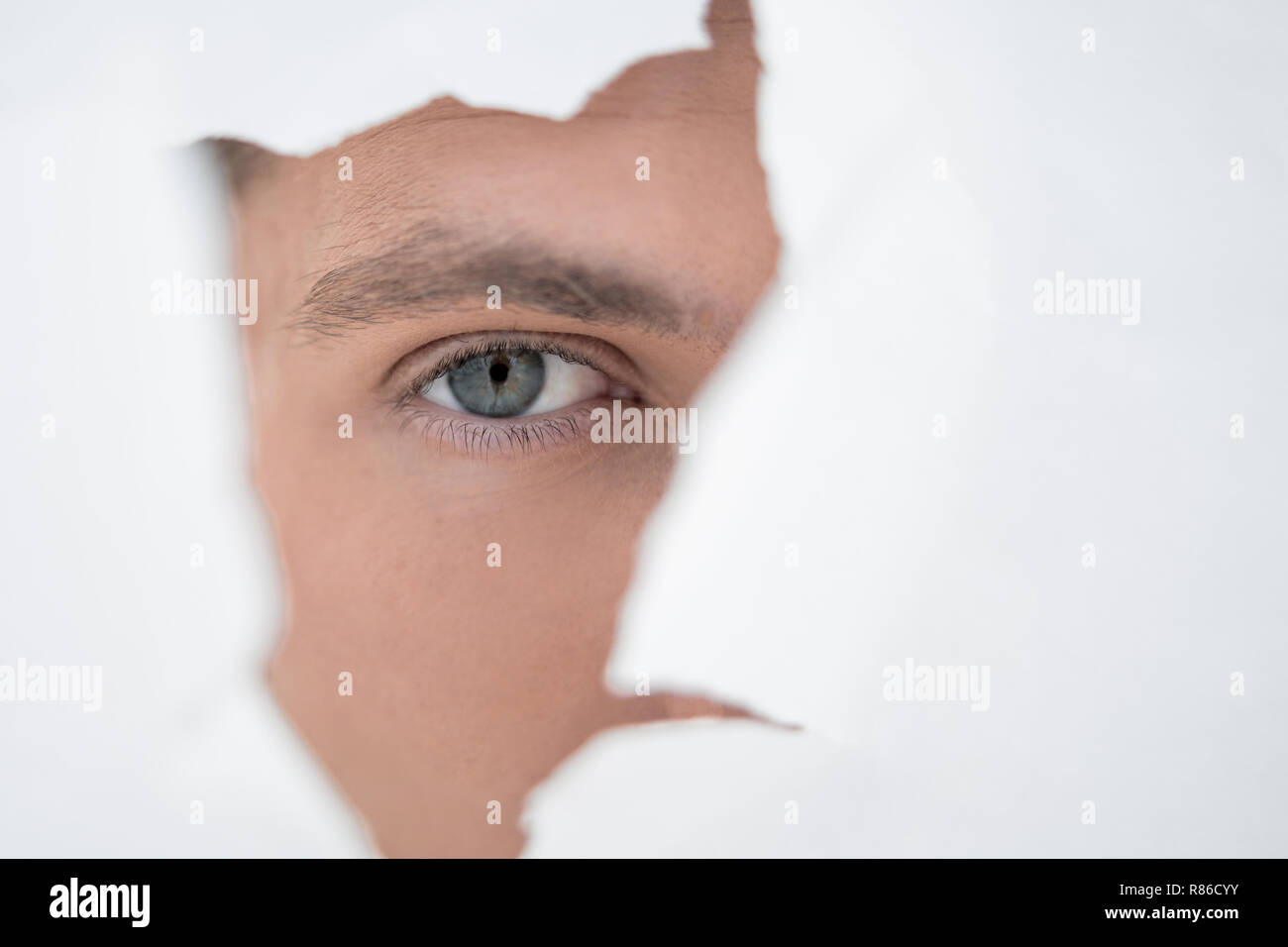 Man Looking Through Hole In Wall High Resolution Stock Photography and ...