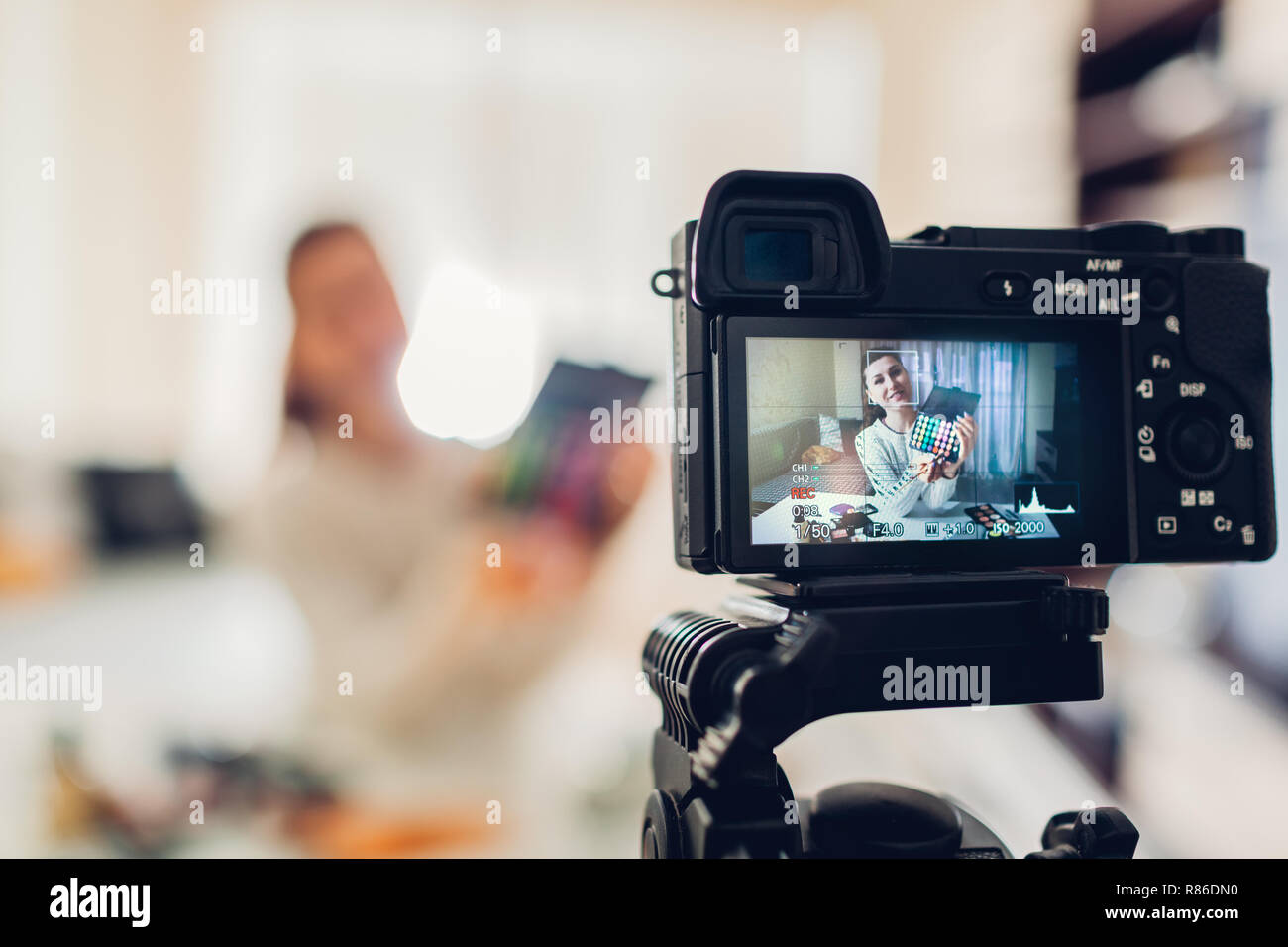 Young woman professional beauty vlogger or blogger recording make up ...