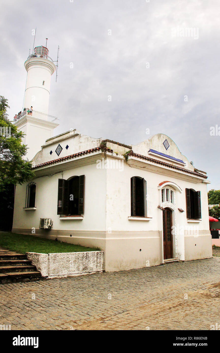 White colonial house and a lighthouse in historic quarter of Colonia ...