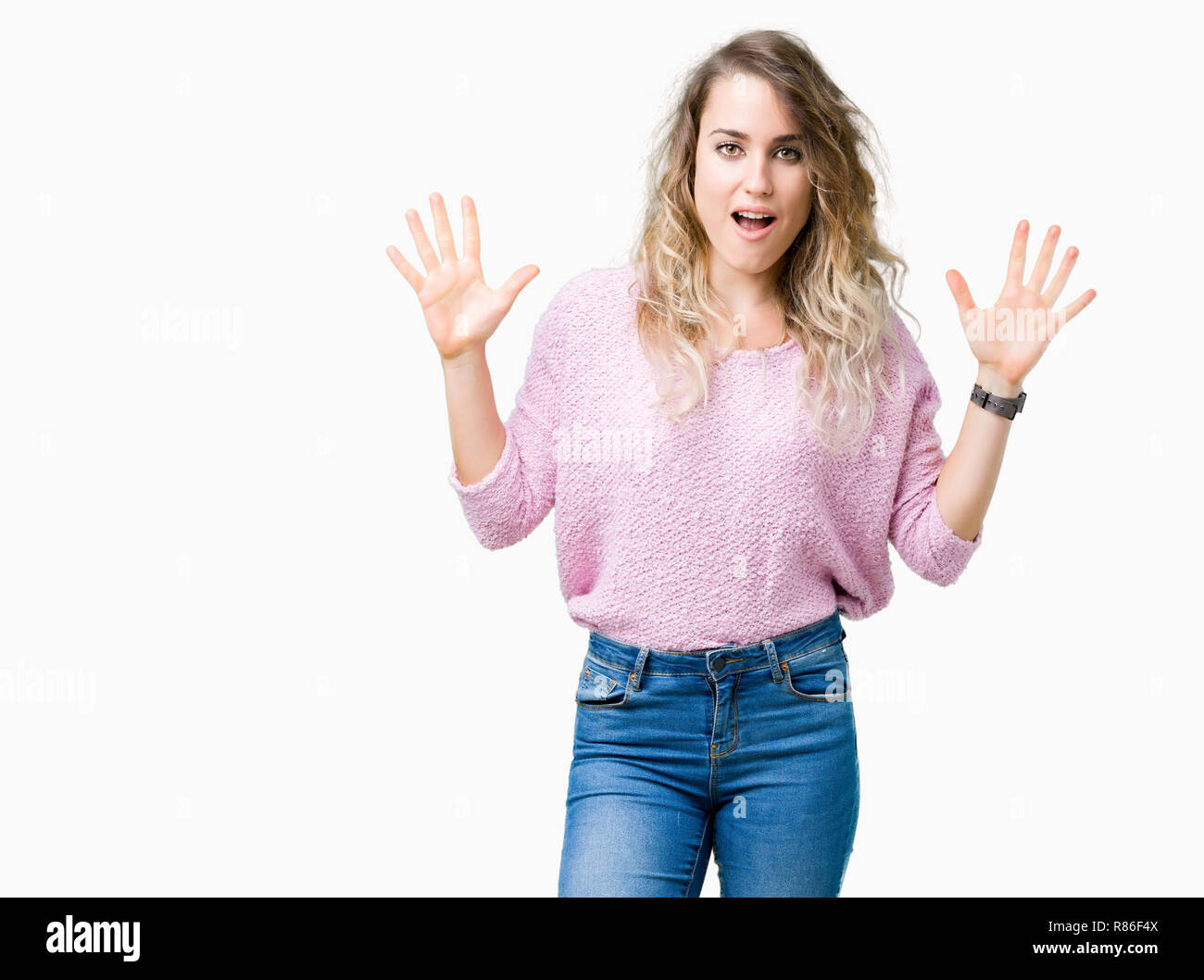 Beautiful young blonde woman over isolated background celebrating crazy ...