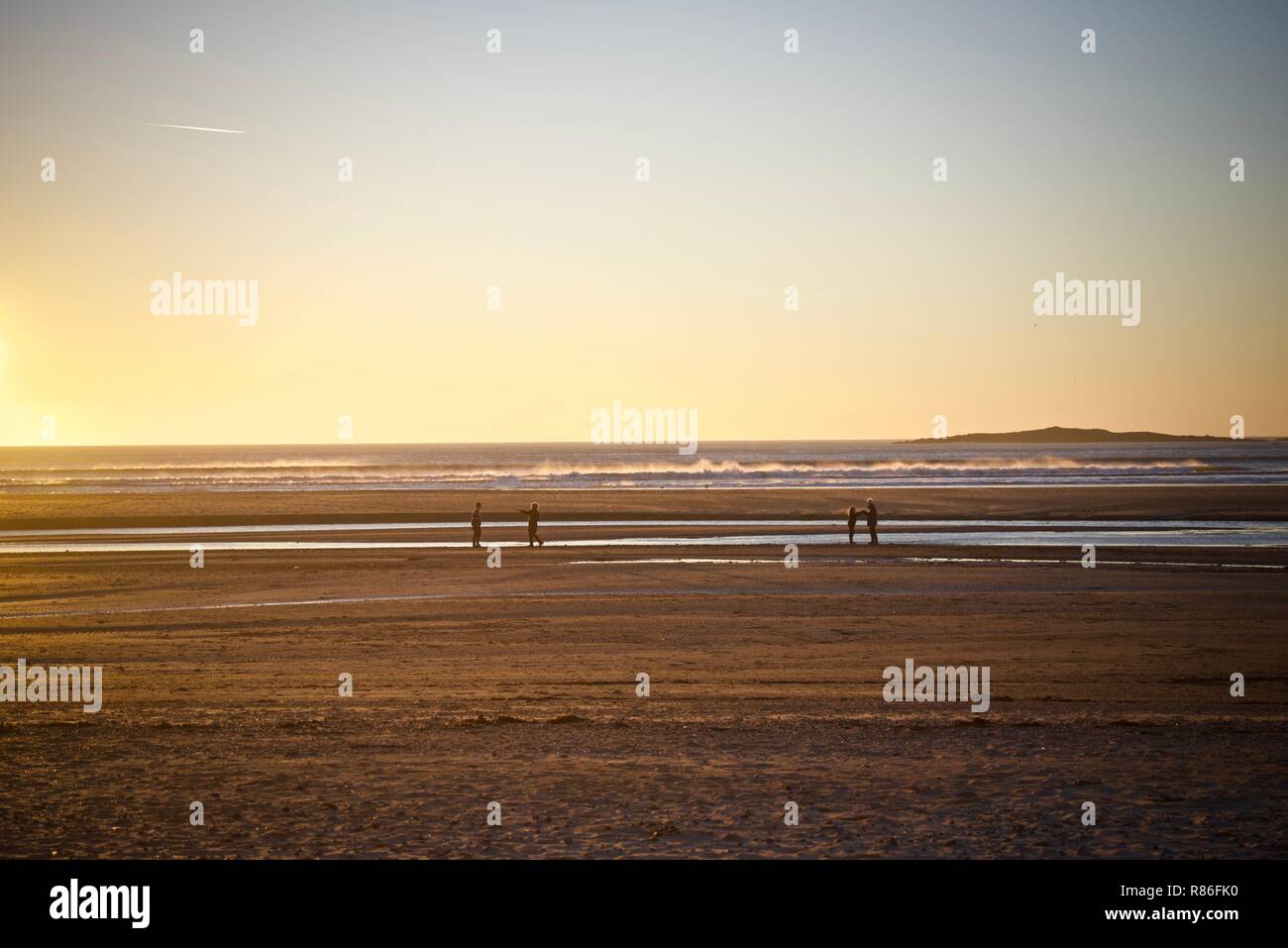 People walking on the beach in Rhosneigr, Anglesey, Wales, UK Stock ...