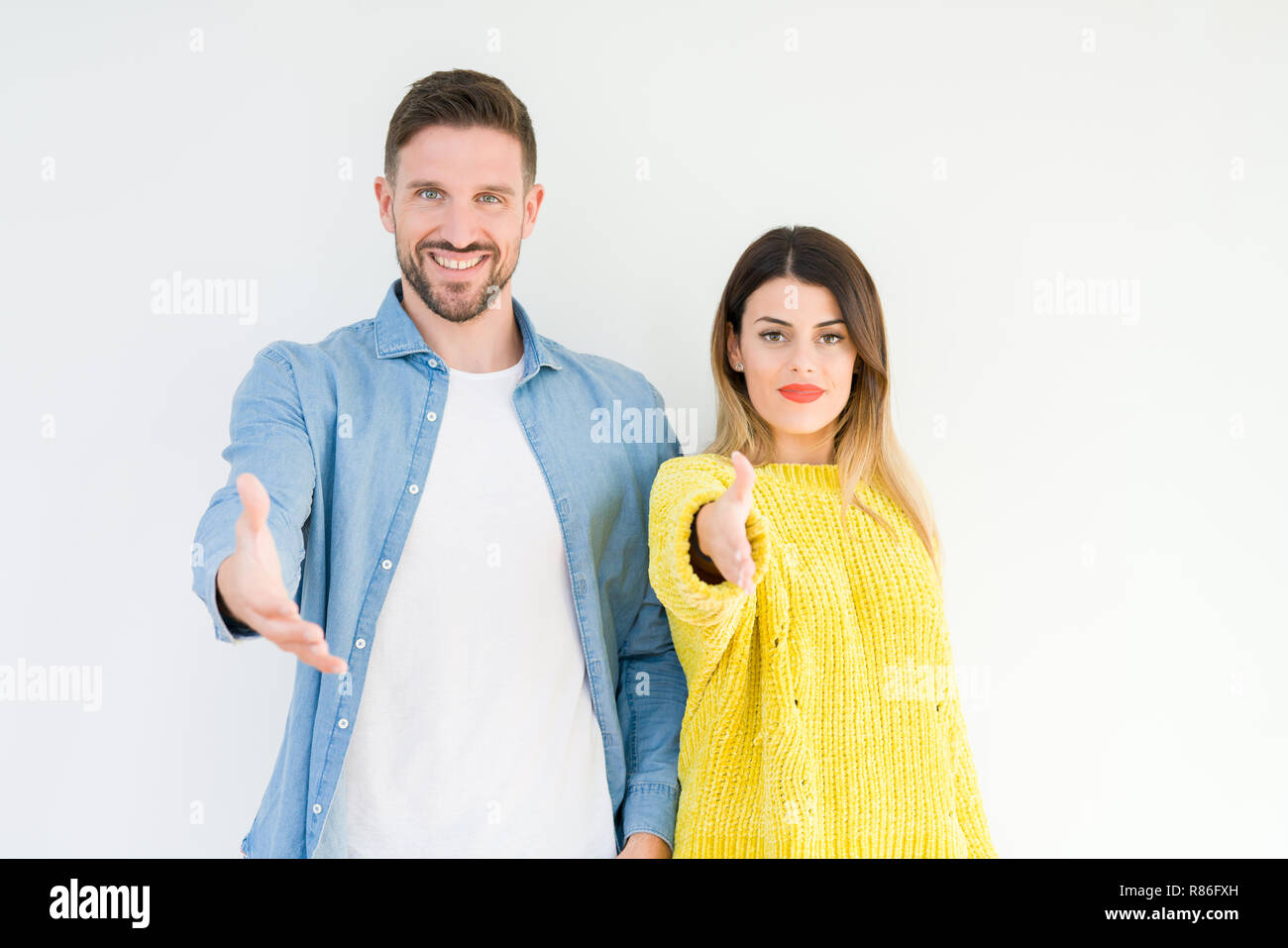 Young beautiful couple togheter over isolated background smiling ...