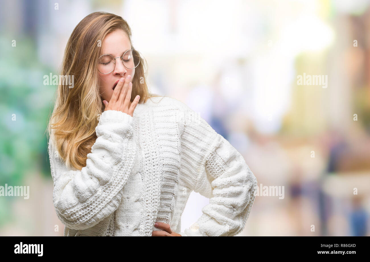 Young beautiful blonde woman wearing winter sweater and sunglasses over ...