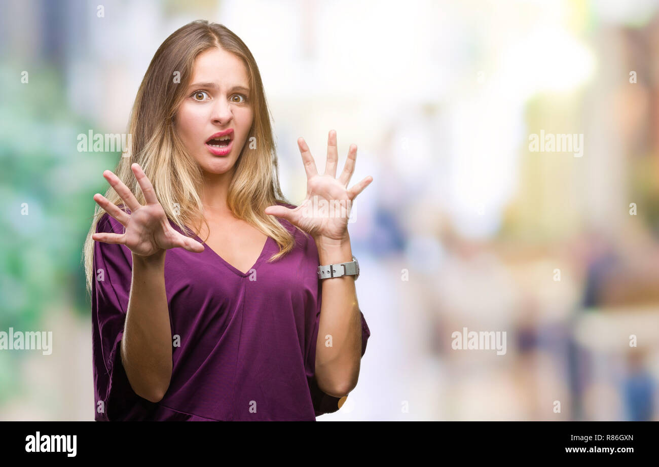 Young beautiful blonde elegant woman over isolated background afraid ...