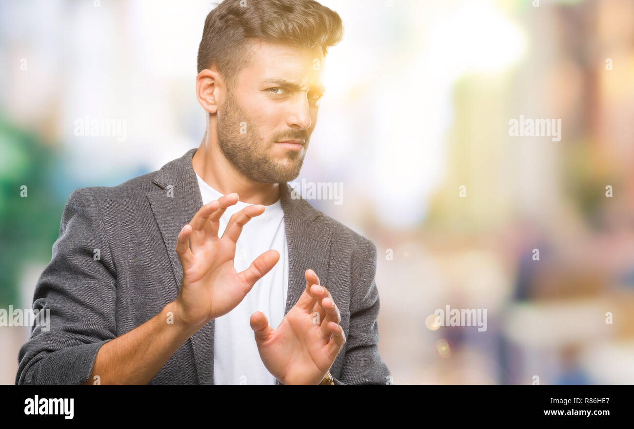 Young handsome business man over isolated background disgusted ...