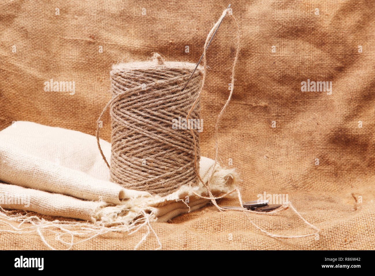 Background of burlap and rope with needle Stock Photo - Alamy