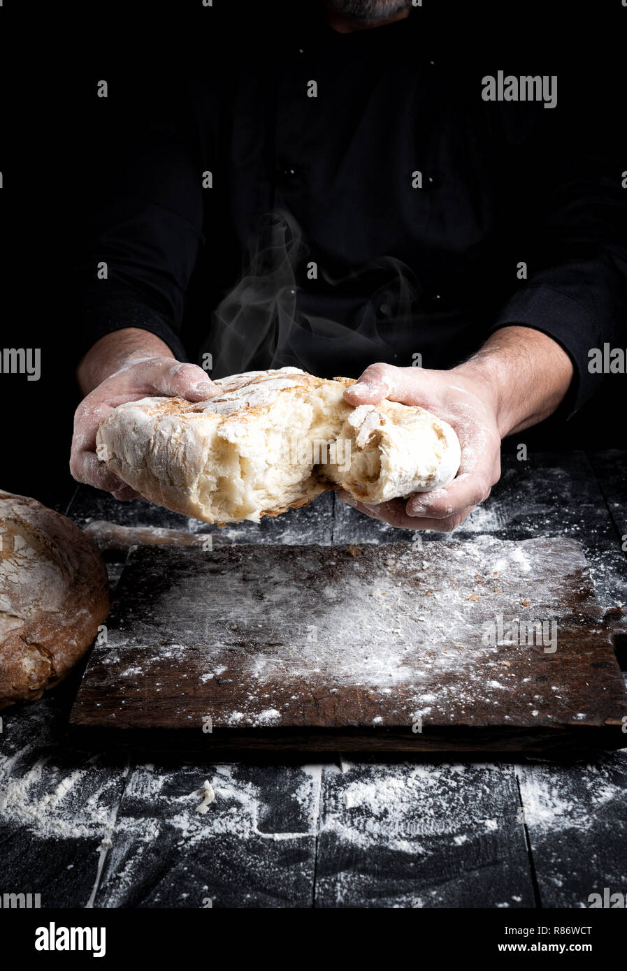 Baker hands breaking homemade bread hi-res stock photography and images ...