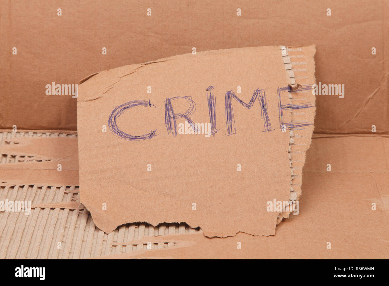 torn corrugated cardboard with the inscription "crime Stock Photo - Alamy