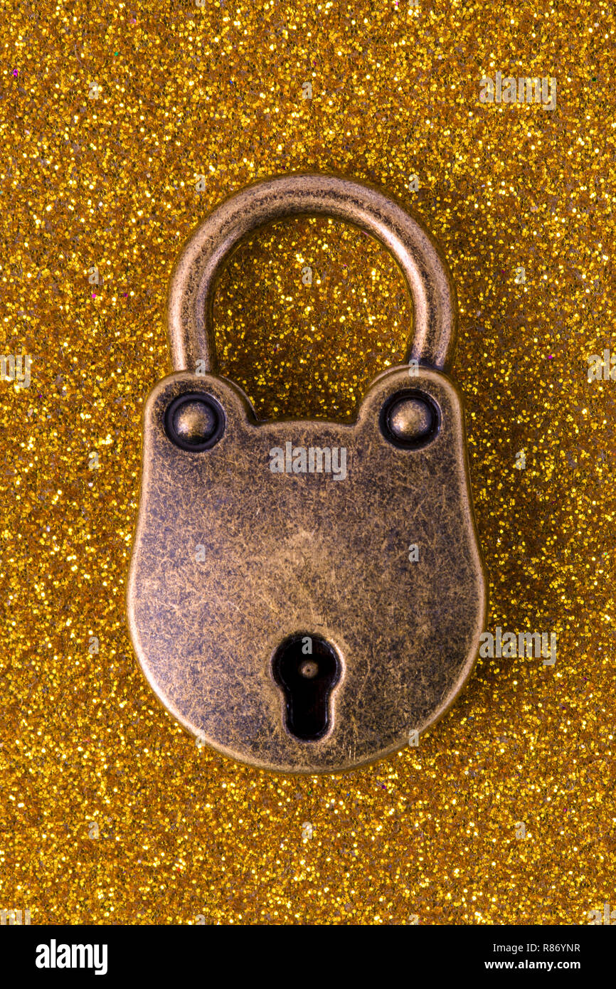 image of bronze lock on a golden background Stock Photo - Alamy