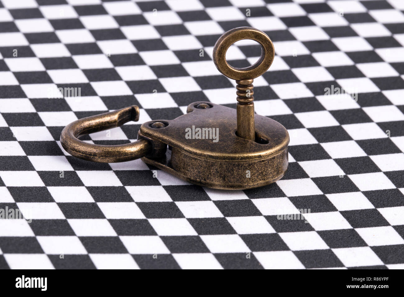 open bronze key lock on a checkerboard surface, background image Stock ...