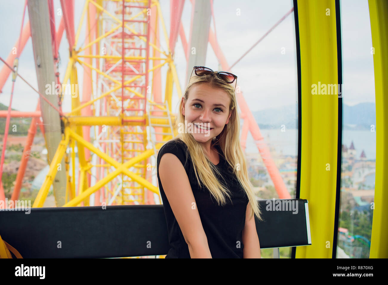 the girl sits in the booth of the Ferris wheel Stock Photo - Alamy