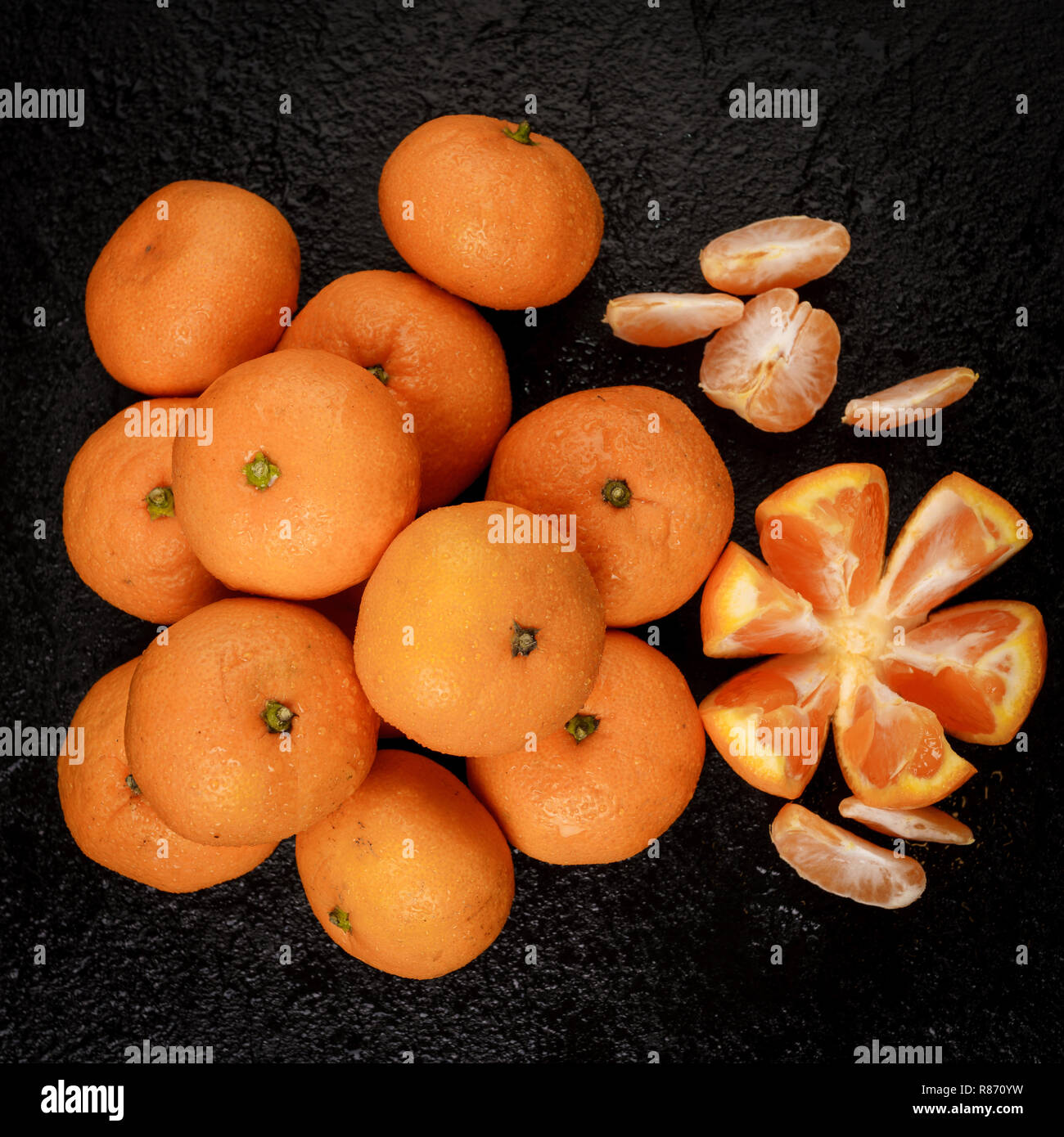 Group of mandarins on black background Stock Photo - Alamy