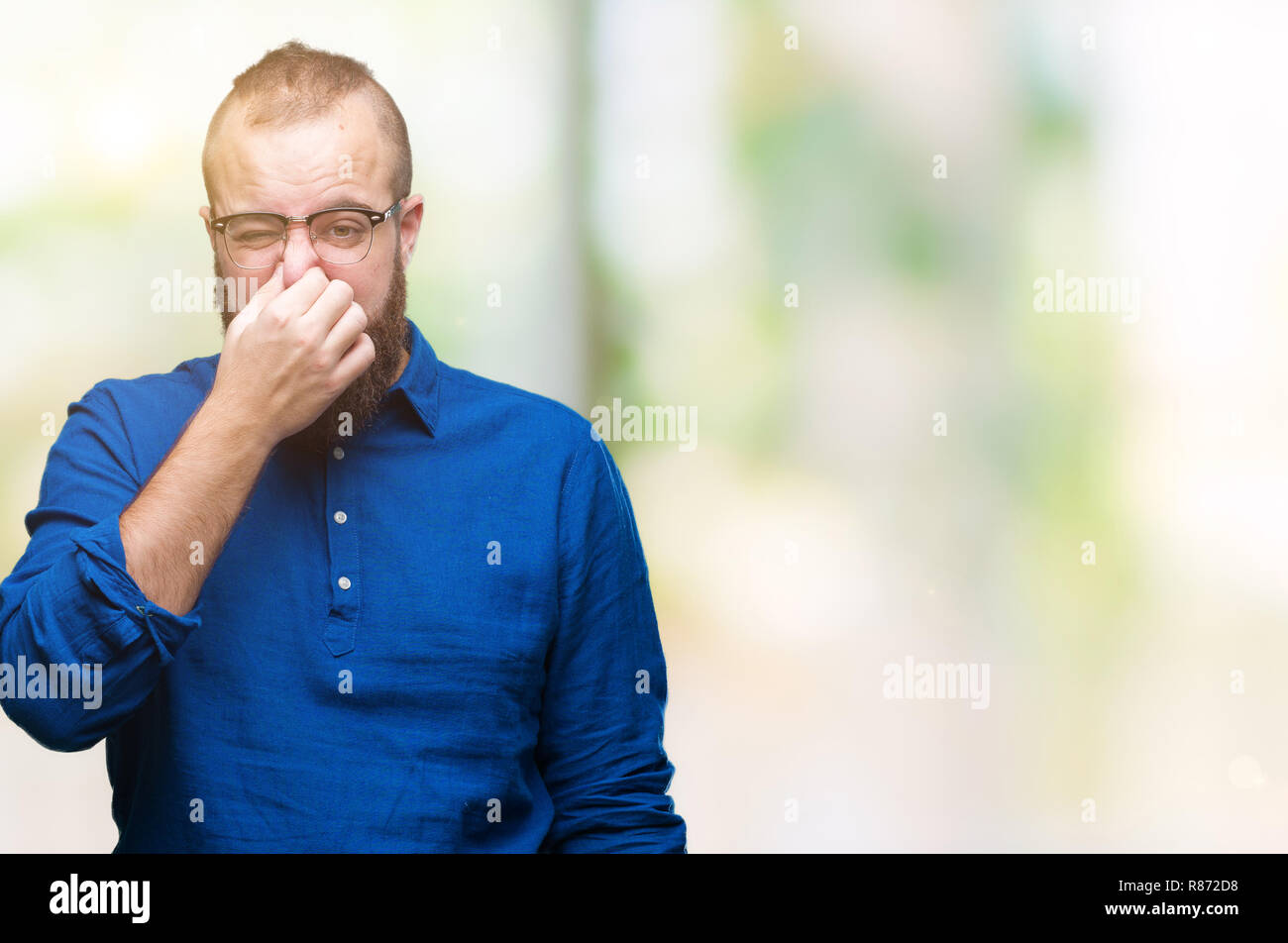 Young caucasian hipster man wearing glasses over isolated background ...