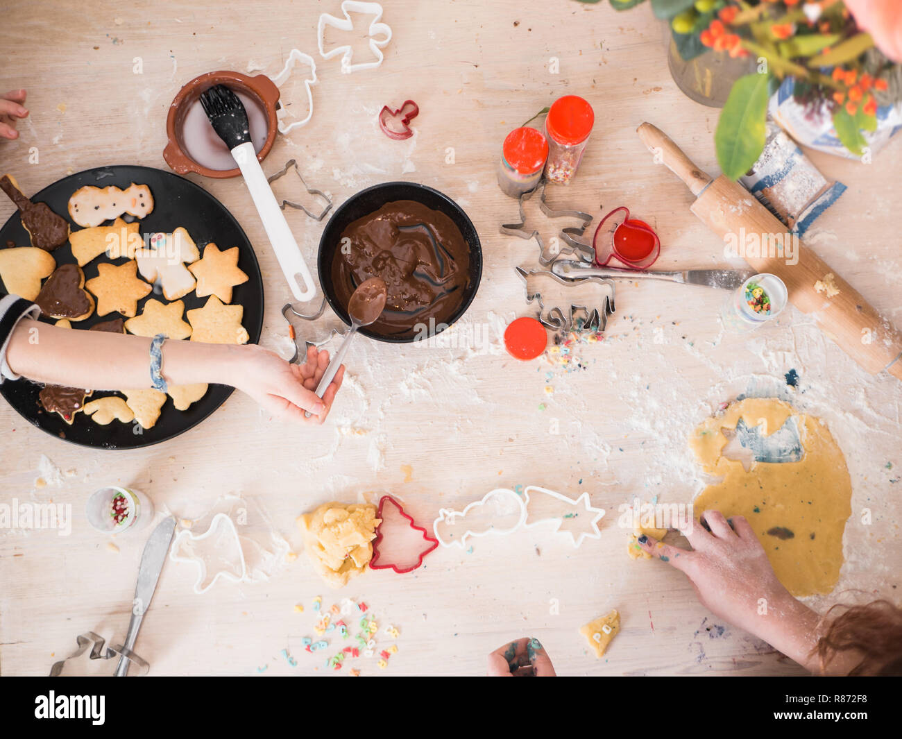 christmas bakery: Girls preparing christmas cookies, top view with ...