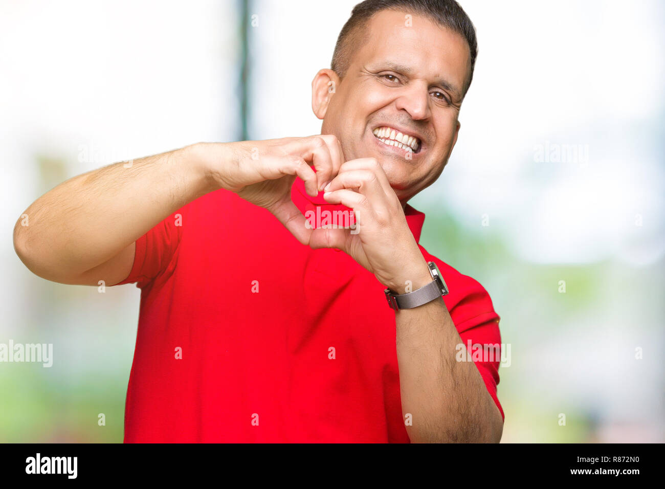 Middle age arab man over isolated background smiling in love showing ...