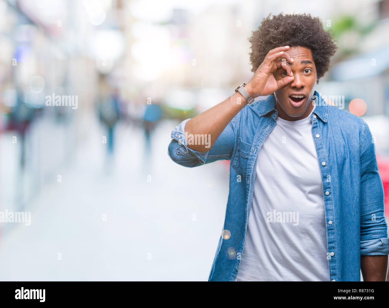 Afro american man over isolated background doing ok gesture shocked ...