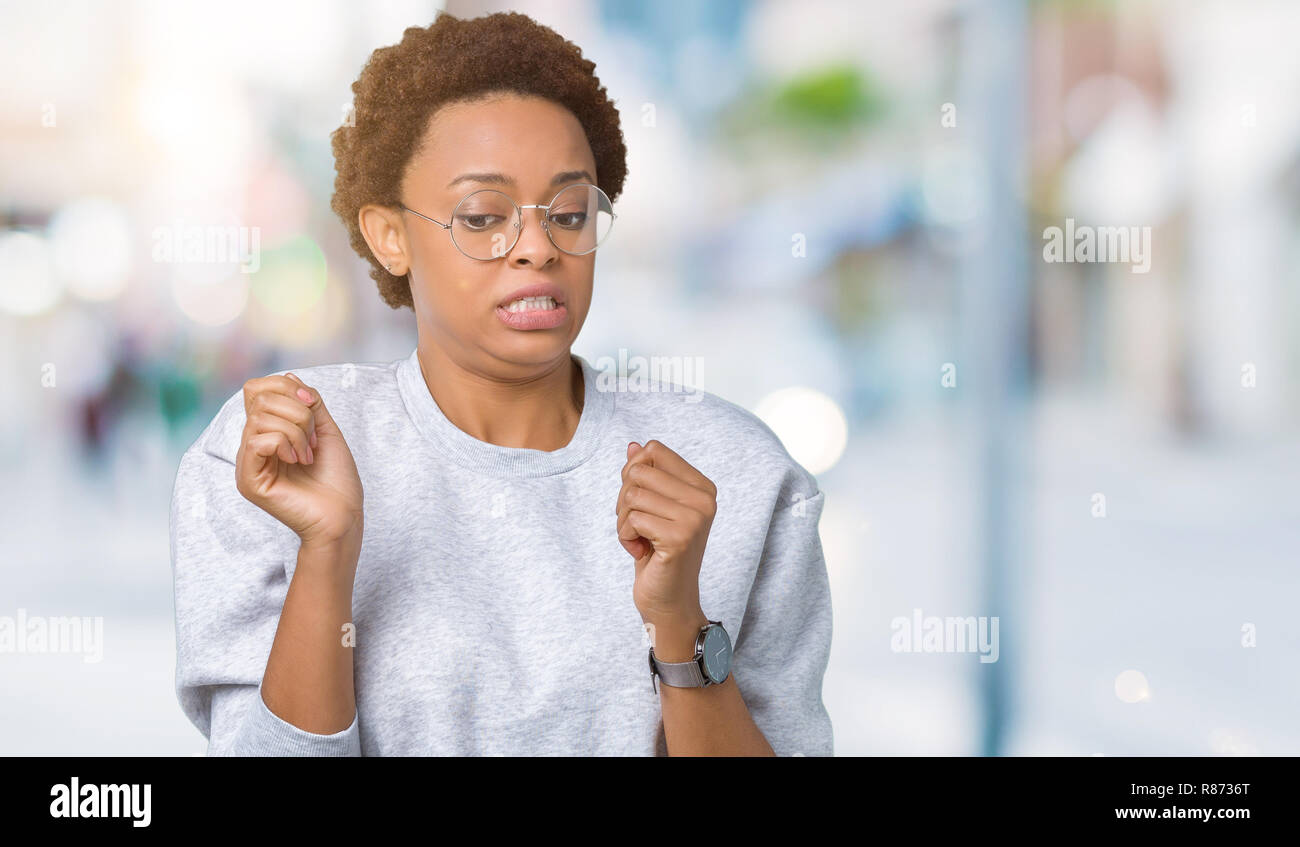 Young beautiful african american woman wearing glasses over isolated ...