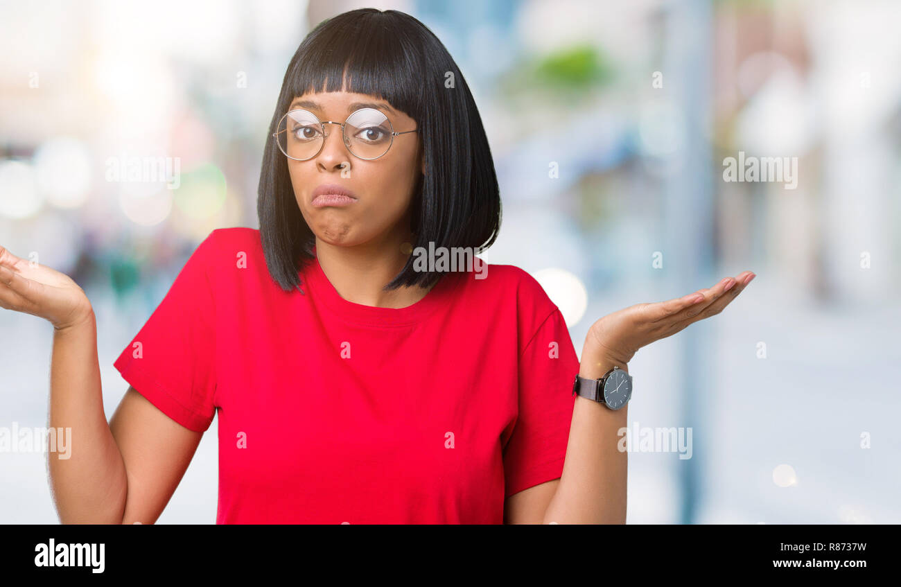 Beautiful young african american woman wearing glasses over isolated ...