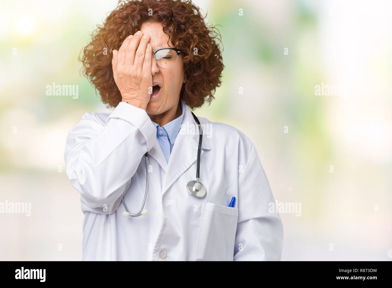 Middle ager senior doctor woman over isolated background Yawning tired ...
