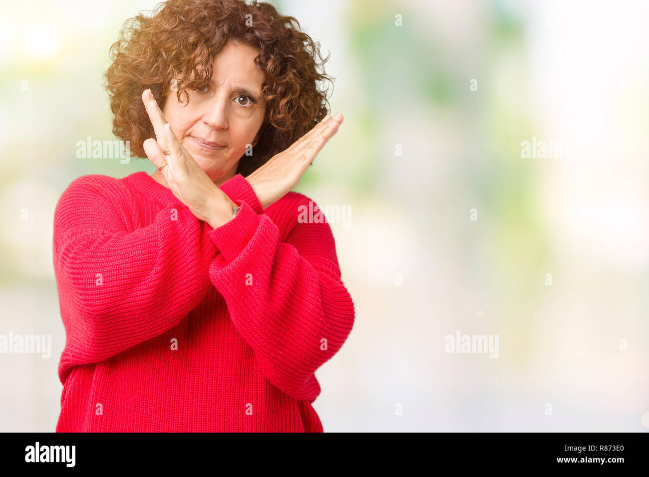 Beautiful middle ager senior woman red winter sweater over isolated ...