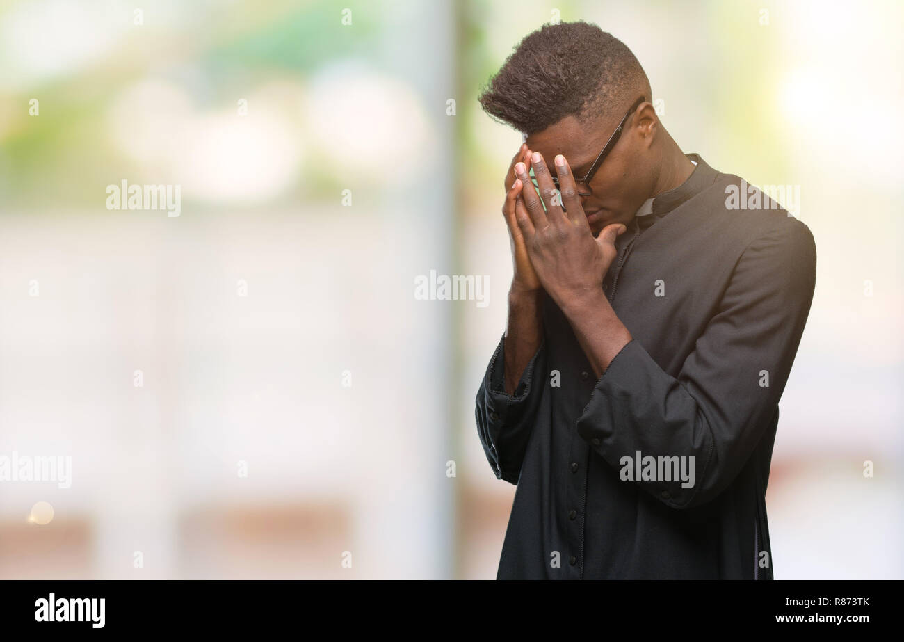 Young african american priest man over isolated background with sad ...