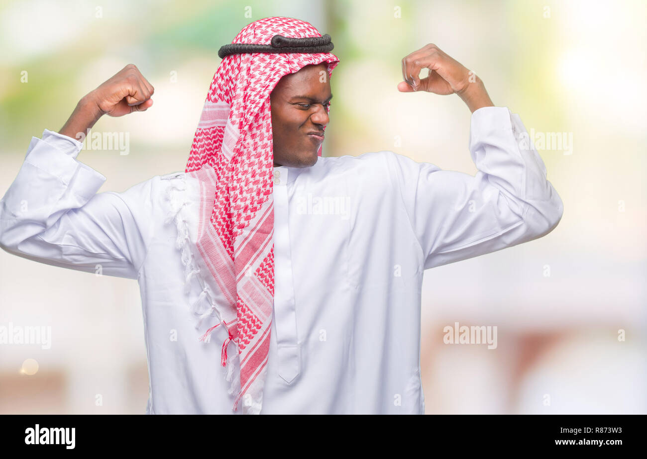 Young arabic african man wearing traditional keffiyeh over isolated ...