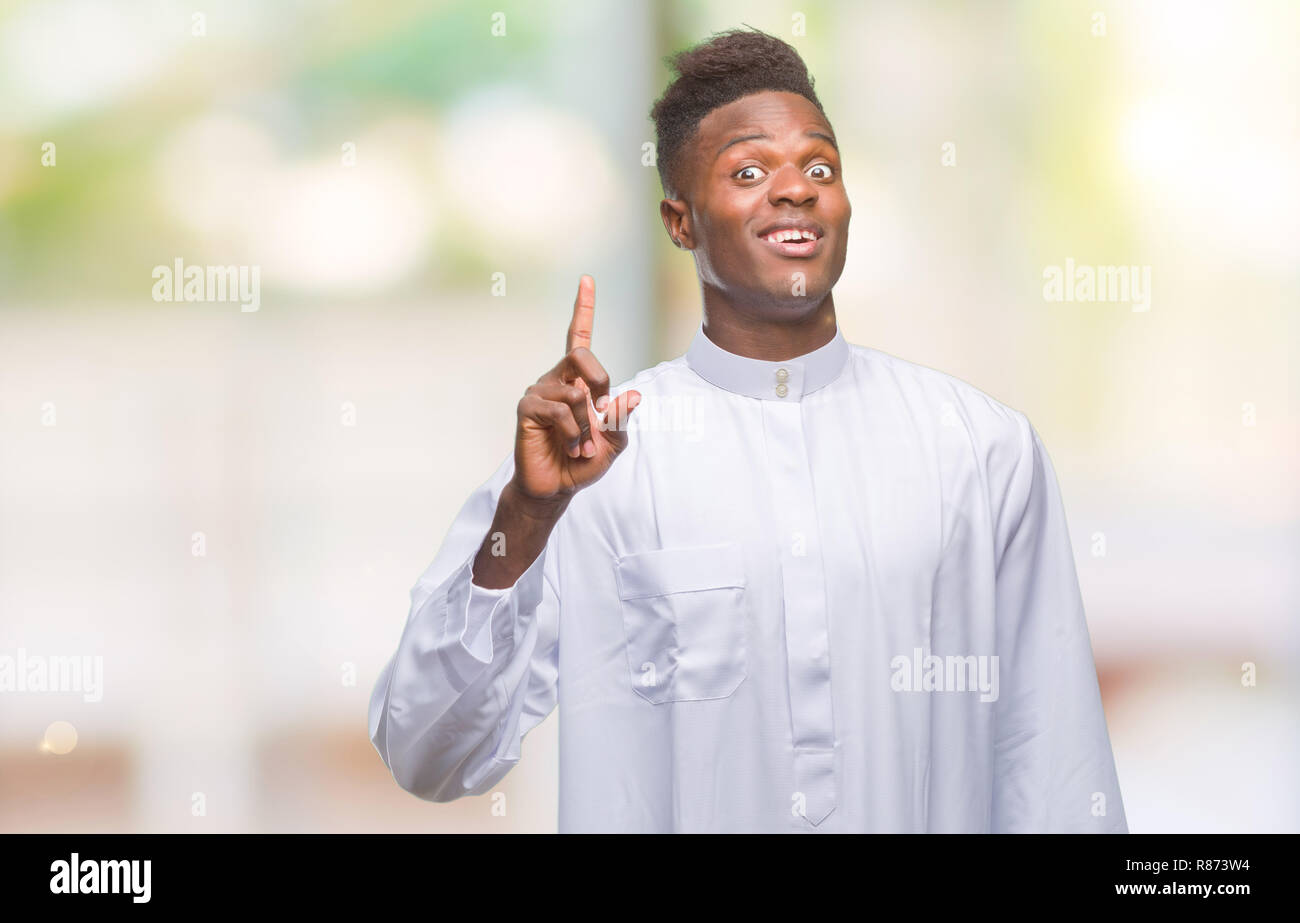 Young arabic african man wearing traditional djellaba over isolated ...