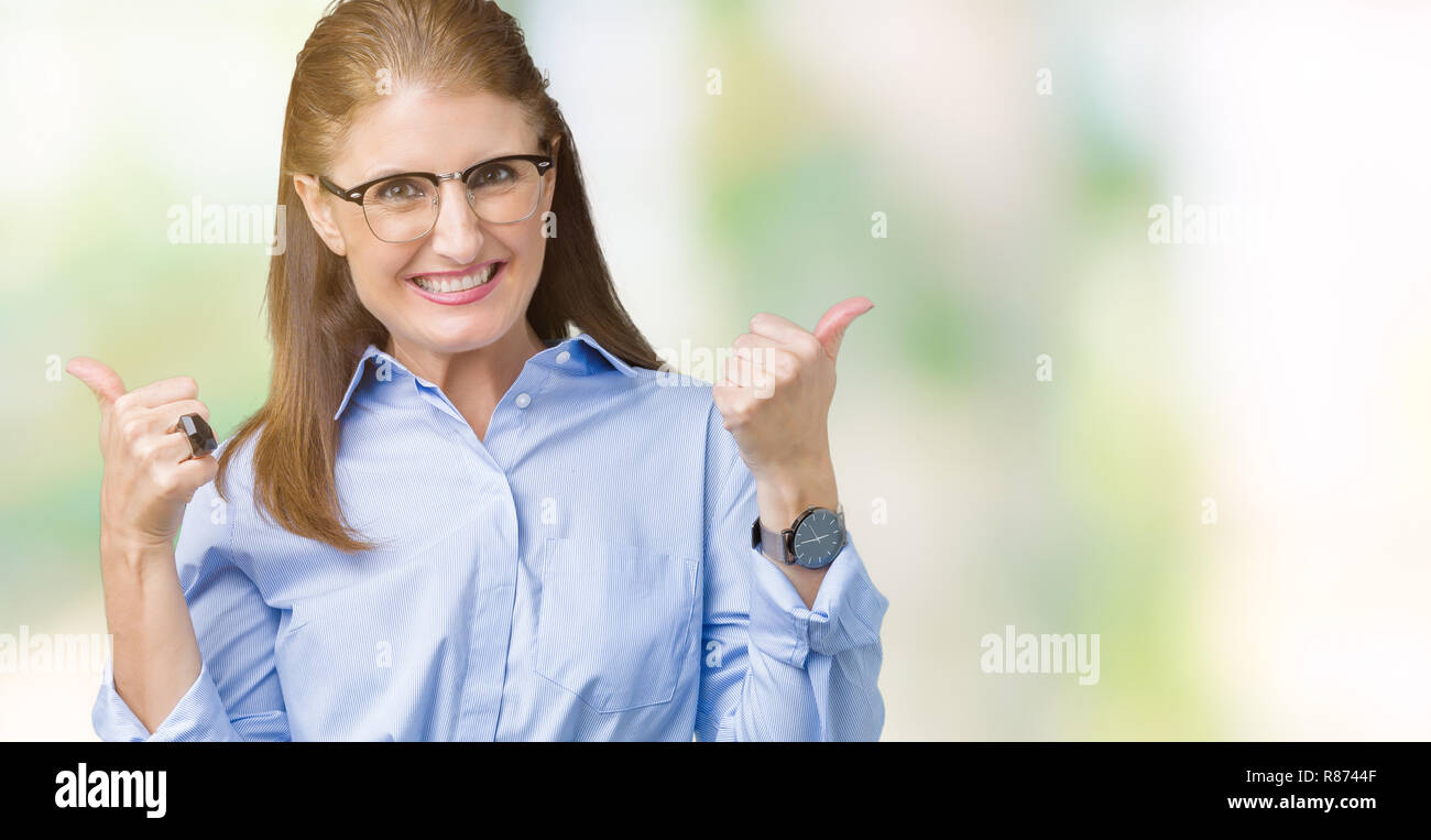 Beautiful middle age mature business woman wearing glasses over ...