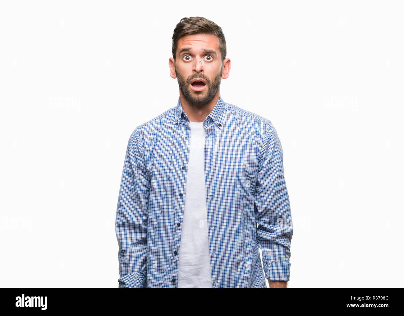 Young handsome man wearing white t-shirt over isolated background ...