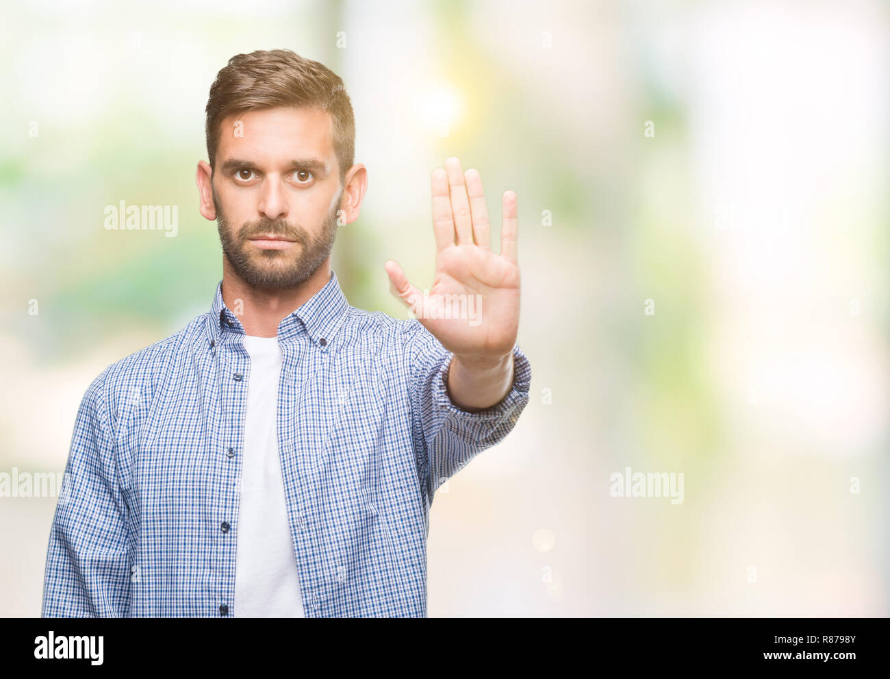 Young handsome man wearing white t-shirt over isolated background doing ...