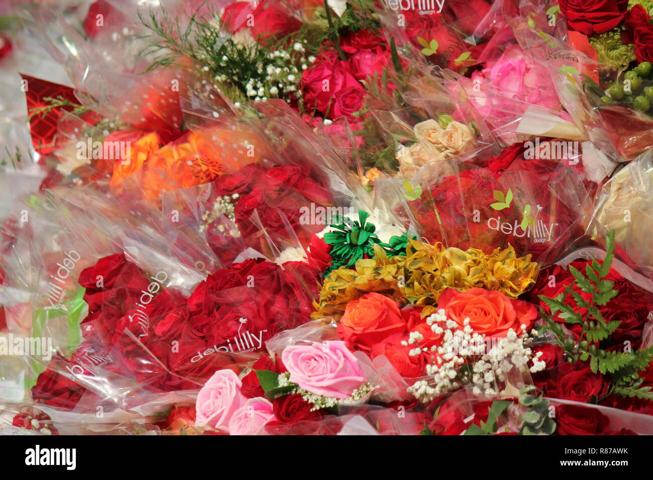Stacks, piles, and a wall full of a variety of showy bouquets of ...