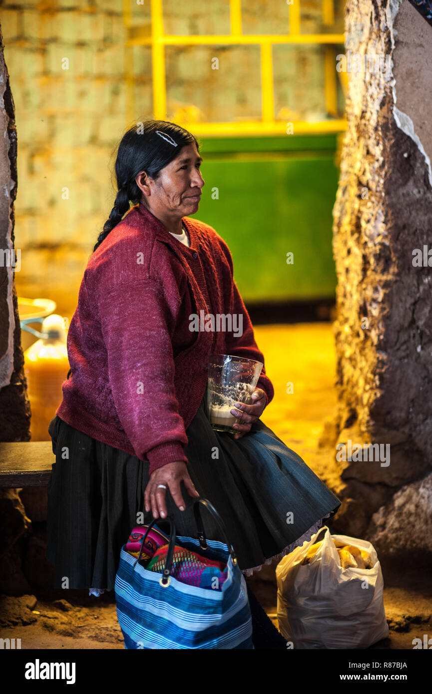 The woman is drinking chicha. Chicha- Inca beer is made from a special ...