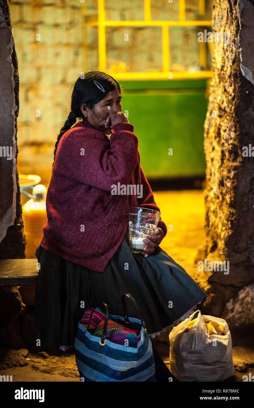 The woman is drinking chicha. Chicha- Inca beer is made from a special ...