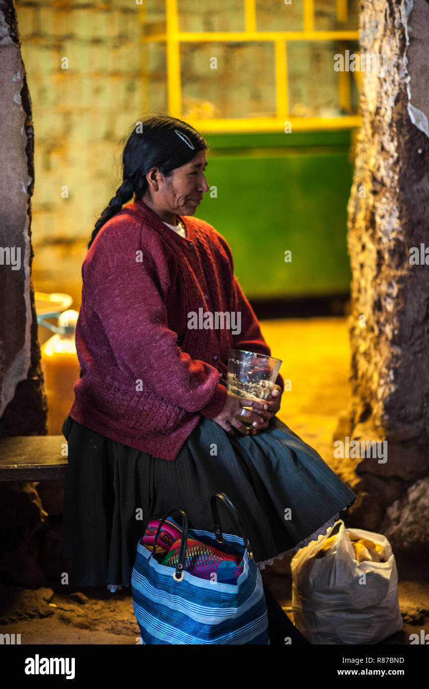 The woman is drinking chicha. Chicha- Inca beer is made from a special ...