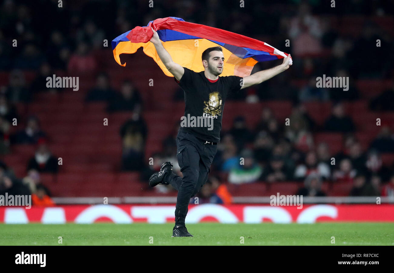 A pitch invader runs across the pitch waving a flag during the UEFA ...