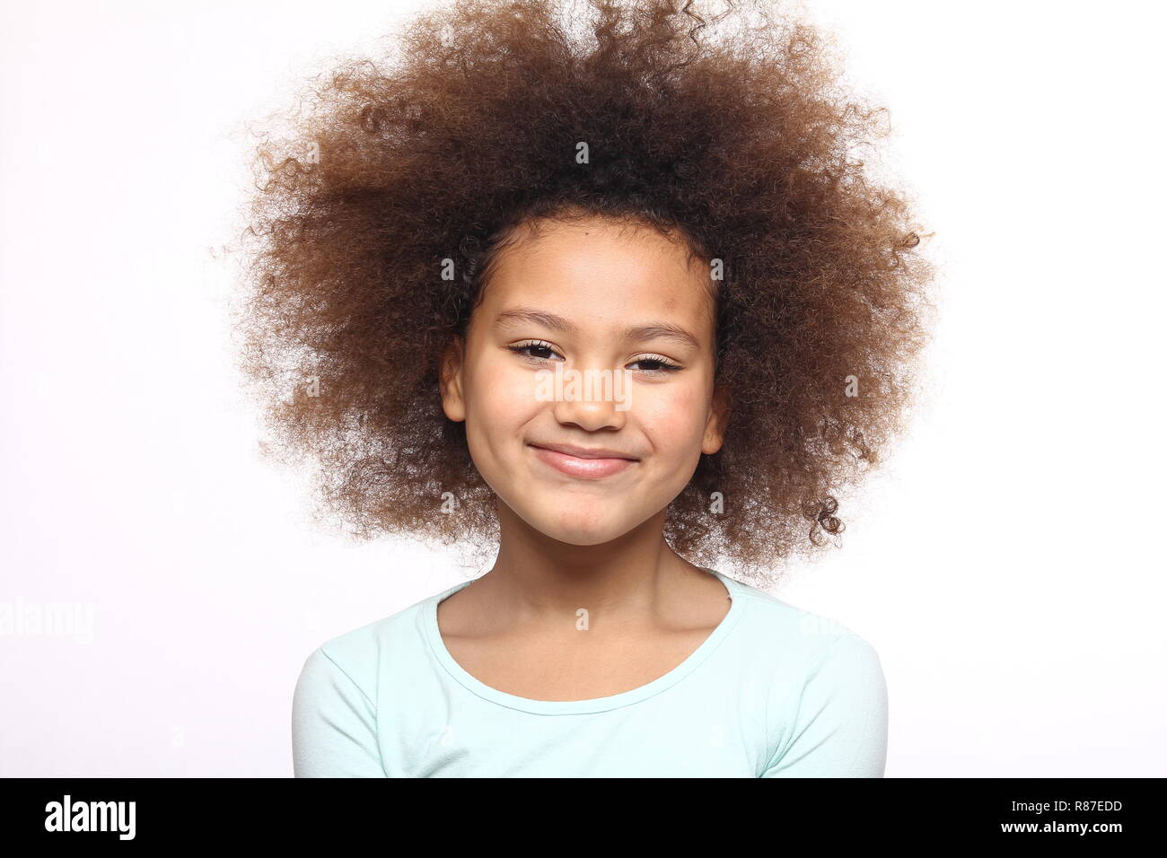 Beautiful little afro girl in front of a background Stock Photo - Alamy