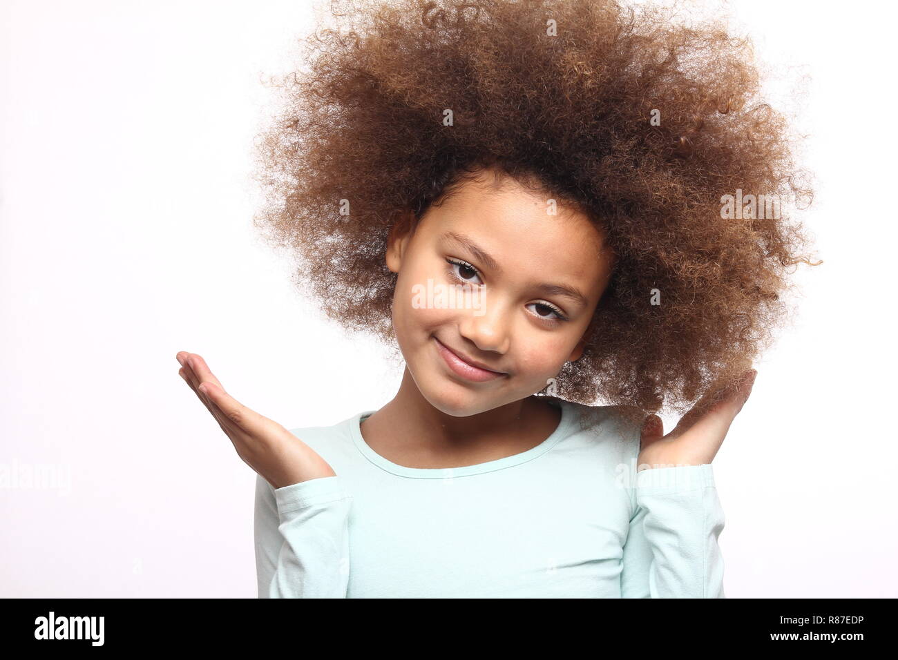 Beautiful little afro girl in front of a background Stock Photo - Alamy
