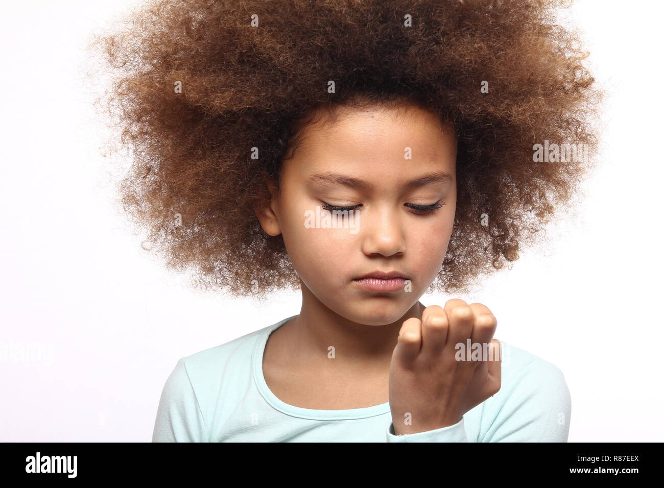 Beautiful little afro girl in front of a background Stock Photo - Alamy