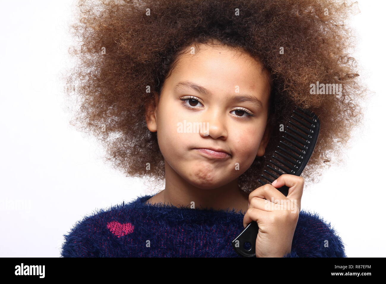 Beautiful little afro girl in front of a background Stock Photo - Alamy
