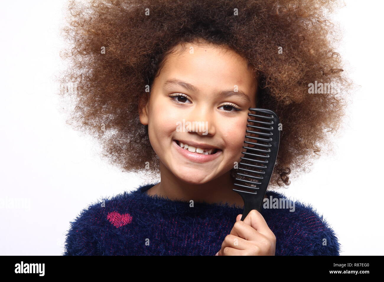 Beautiful little afro girl in front of a background Stock Photo - Alamy