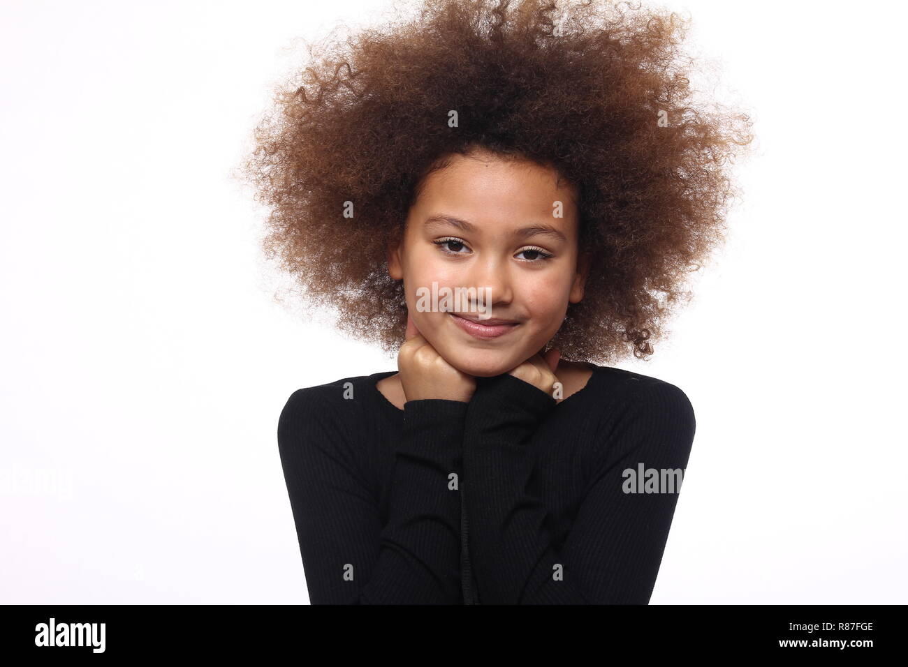 Beautiful little afro girl in front of a background Stock Photo - Alamy
