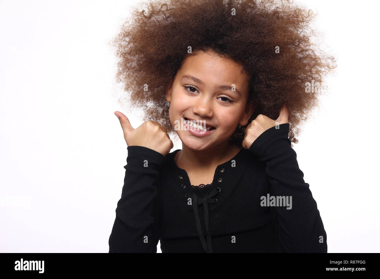 Beautiful little afro girl in front of a background Stock Photo - Alamy