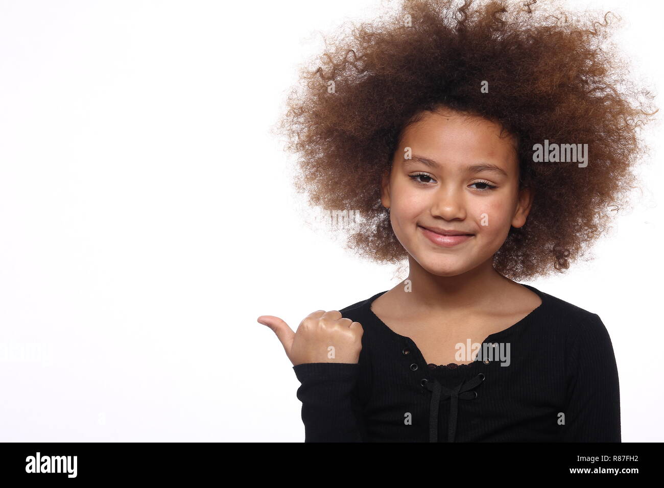 Beautiful little afro girl in front of a background Stock Photo - Alamy