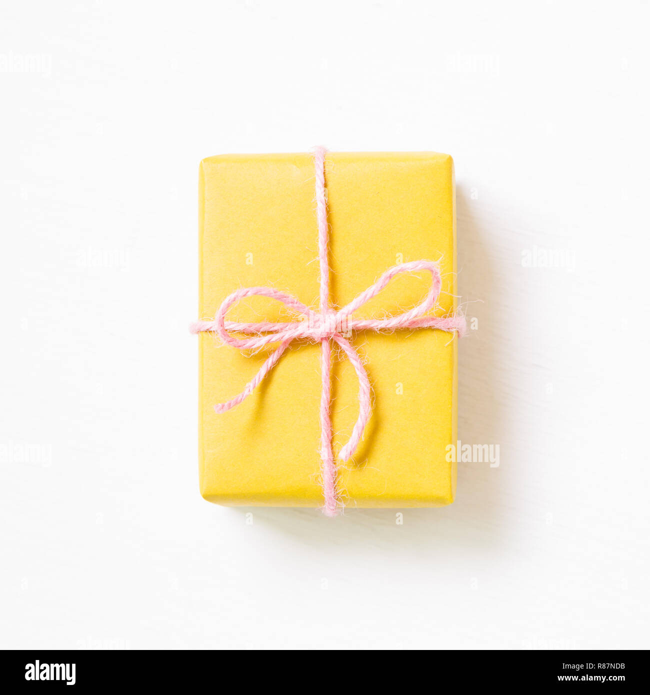 Yellow gift box isolated on white background Stock Photo - Alamy