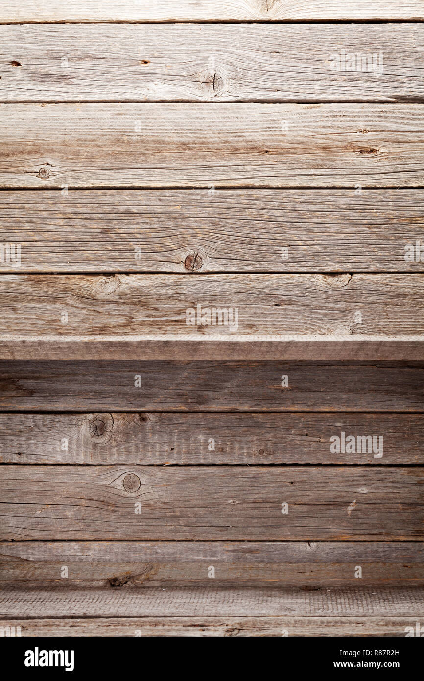 Empty wooden shelves in front of wooden wall with copy space Stock ...