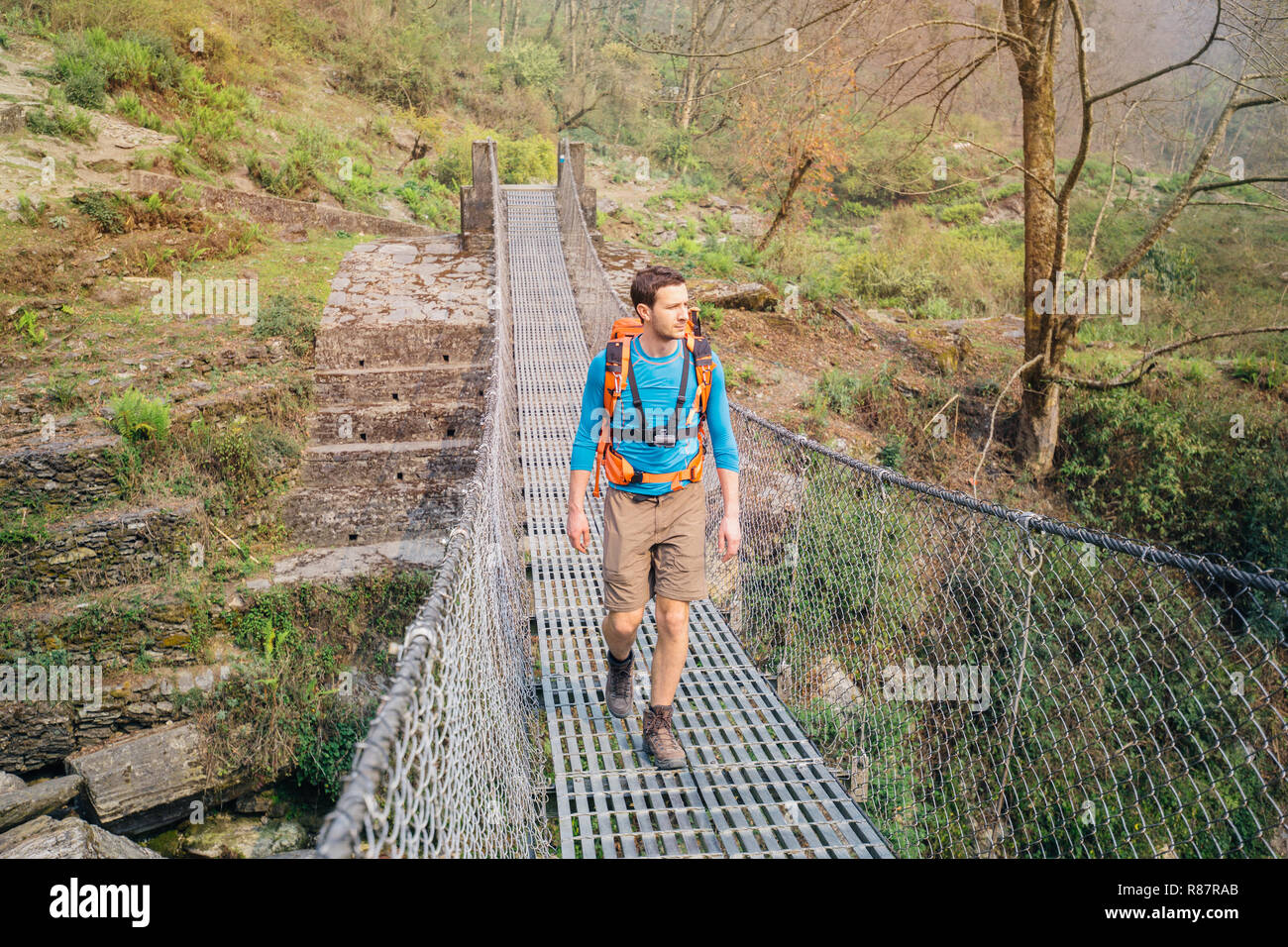 Man crossing footbridge hi-res stock photography and images - Alamy