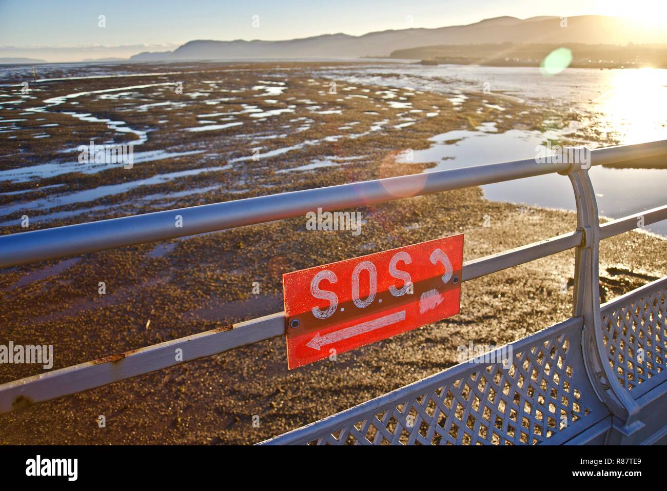 A hand painted SOS information sign on the railings of Bangor Pier at ...