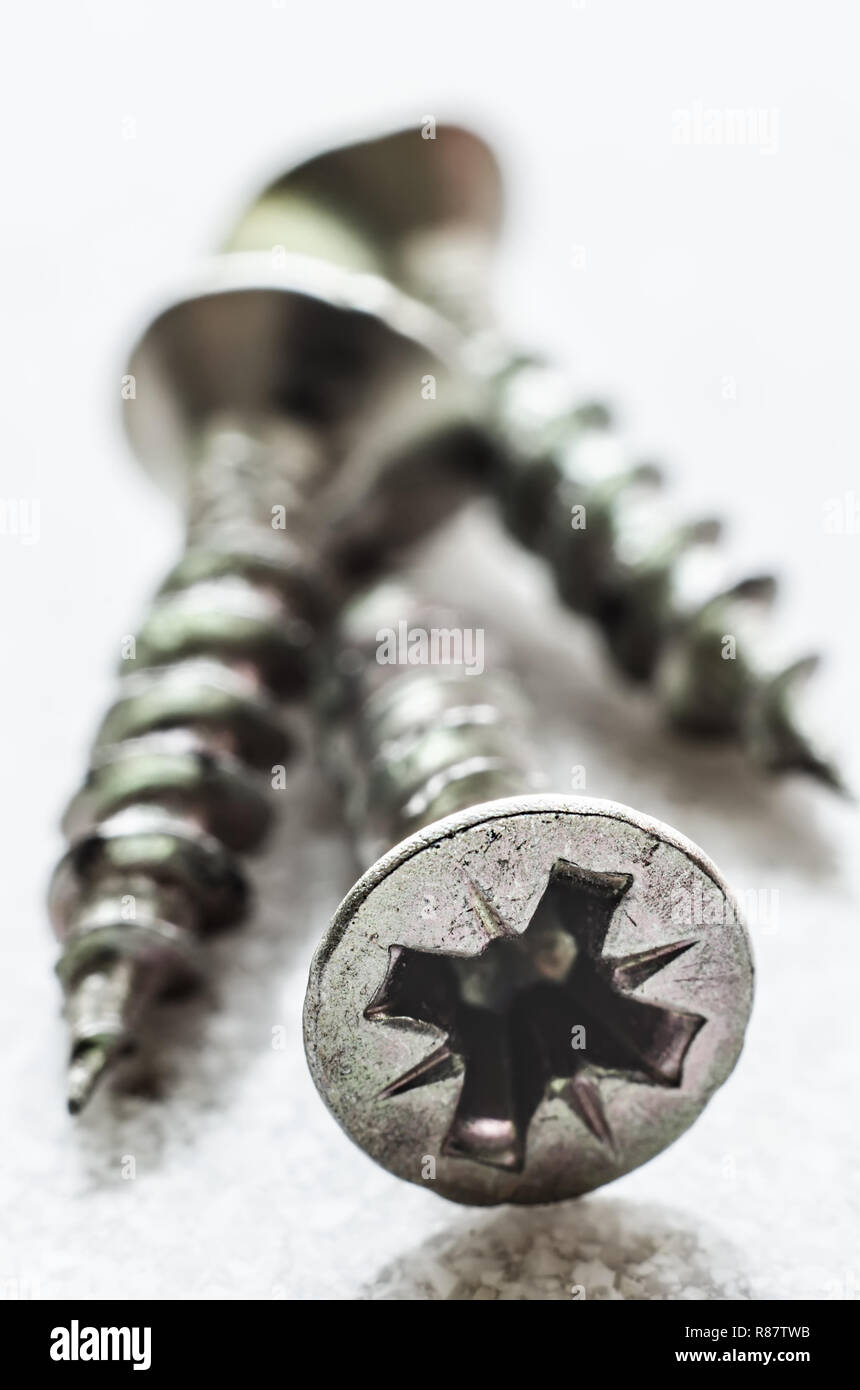 three screws on a white background Stock Photo - Alamy